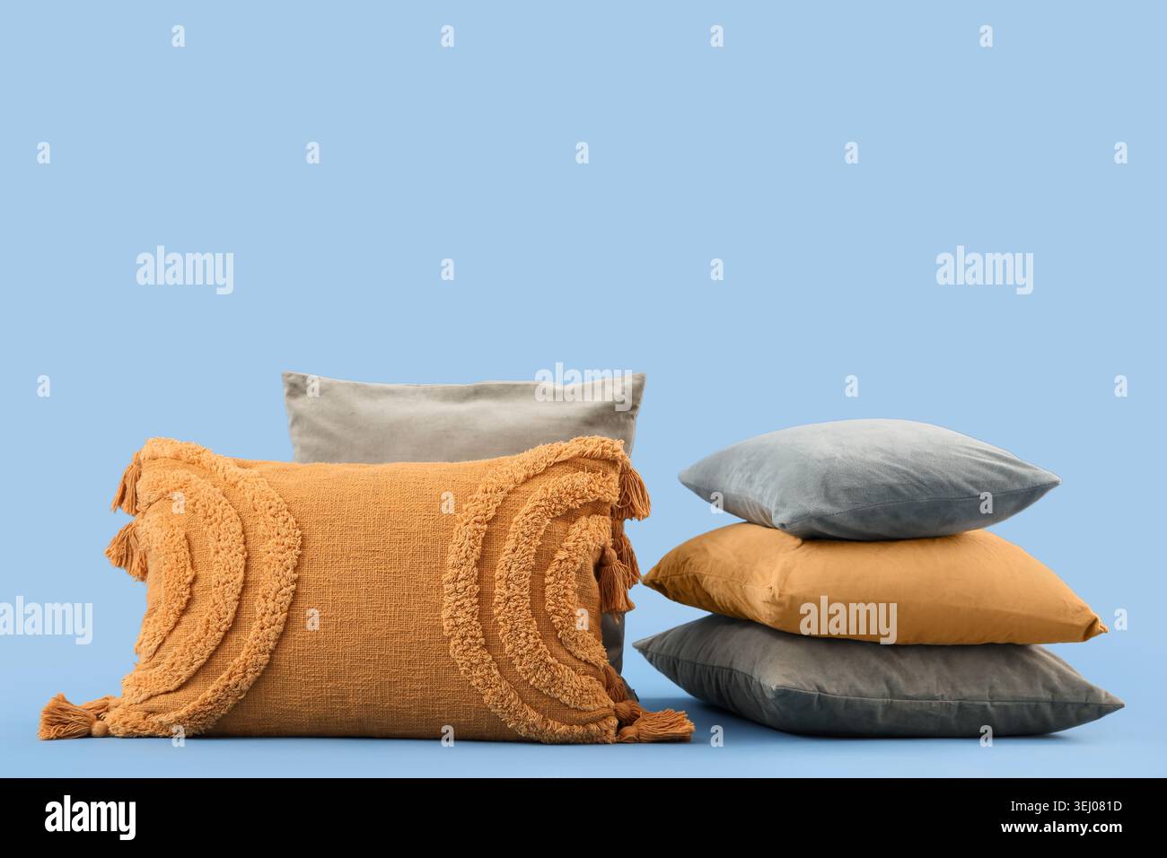 Different pillows on blue background Stock Photo - Alamy
