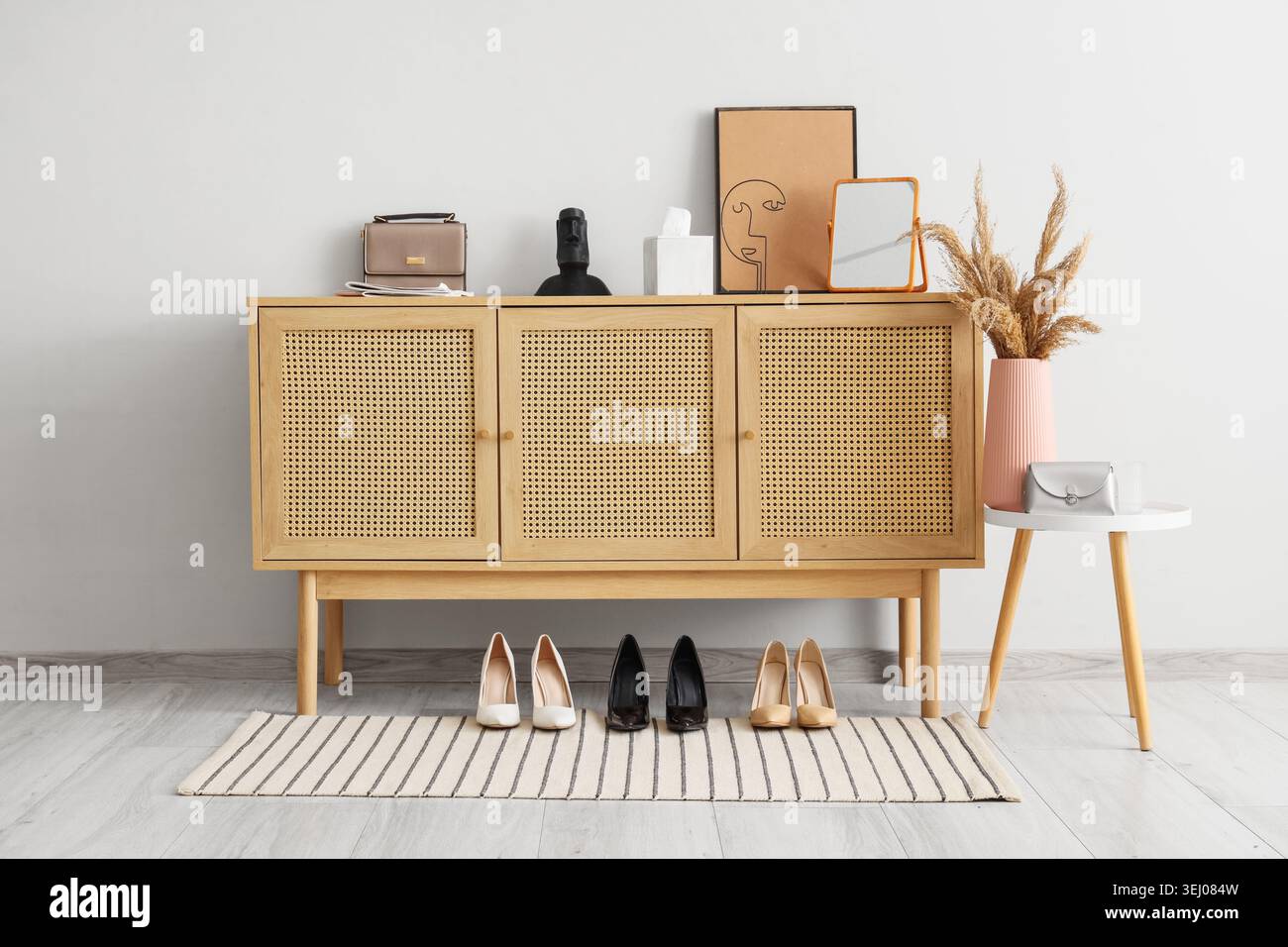 Interior of hallway with commode, table and shoes Stock Photo - Alamy