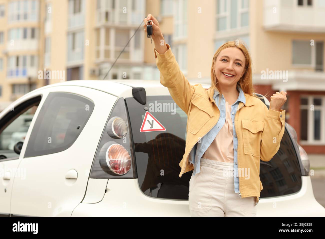 Mature woman with key near car outdoors Stock Photo - Alamy