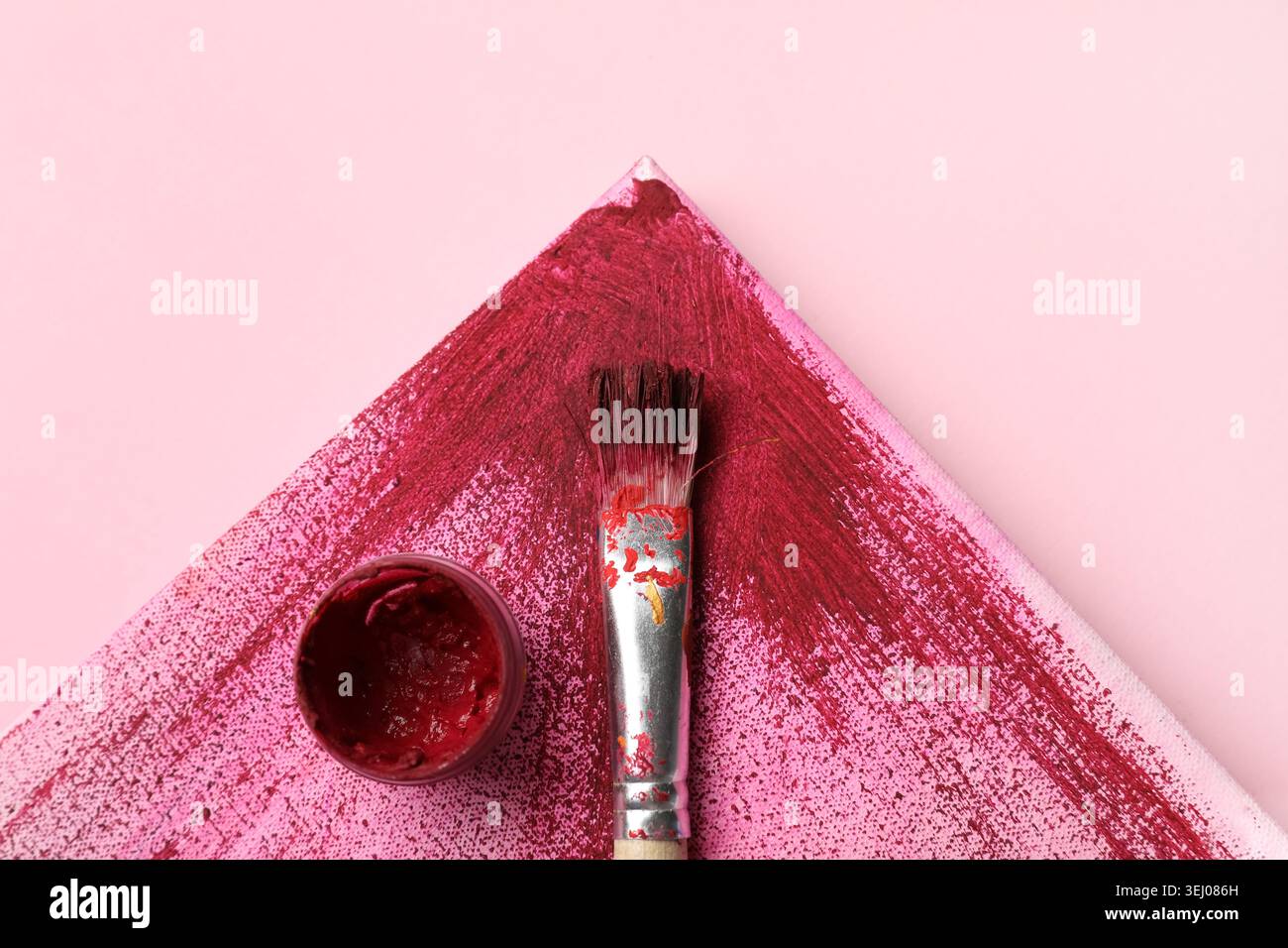 Artist brush, paint and canvas on pink background, closeup Stock Photo ...