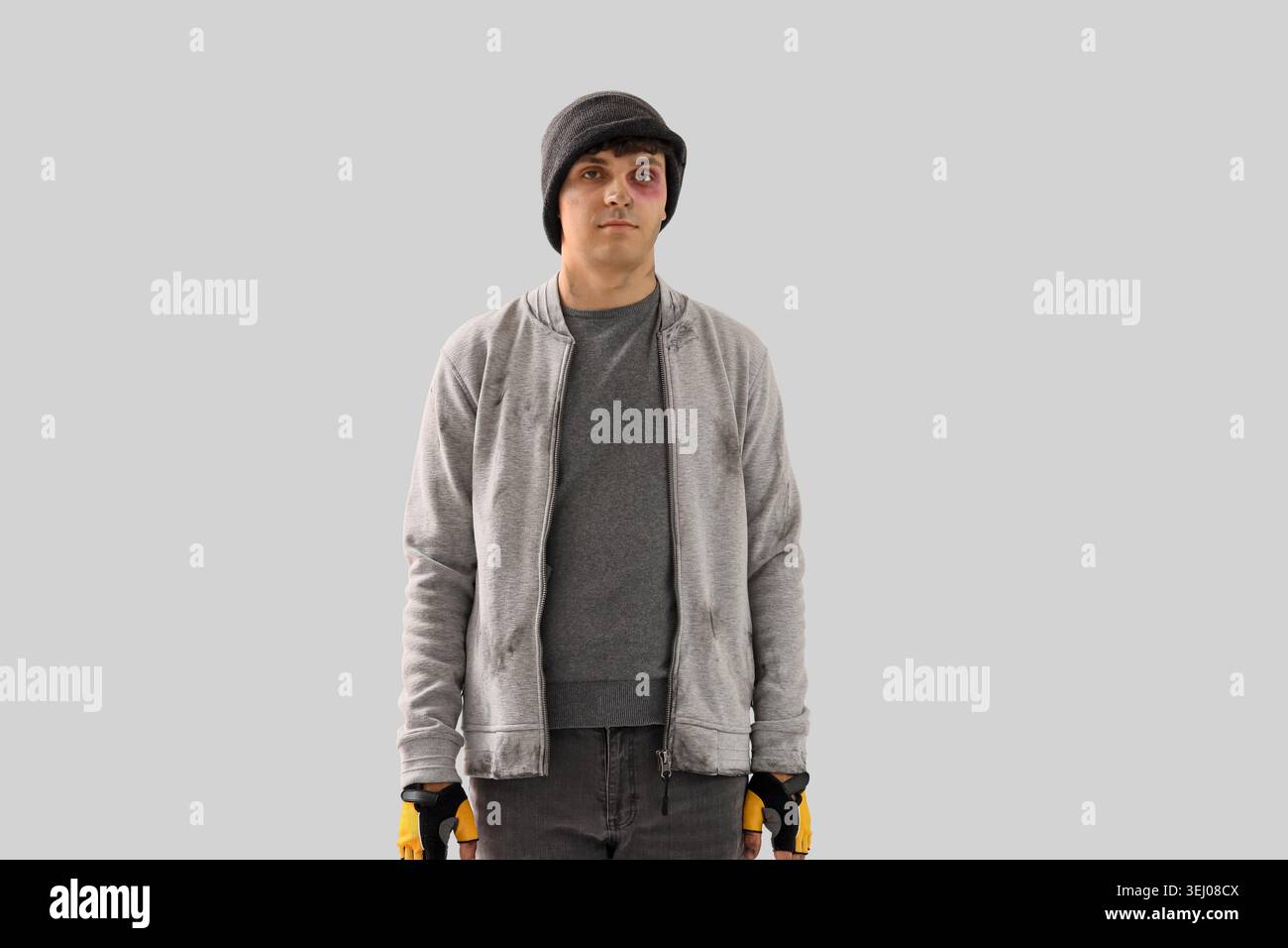 Young homeless man on light background Stock Photo - Alamy