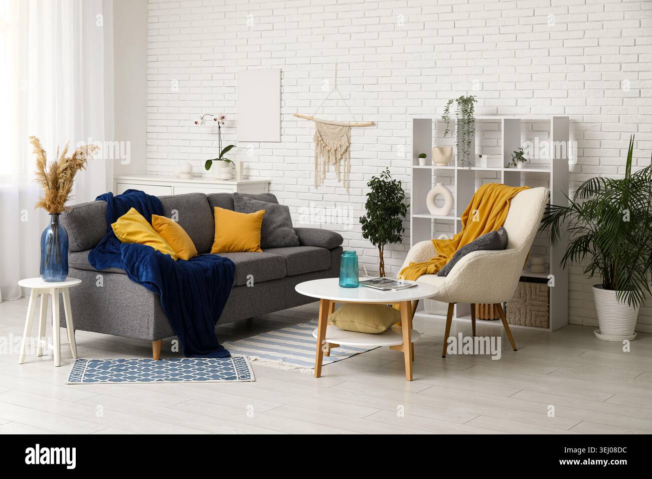 Interior of light living room with soft couch, armchair and coffee ...