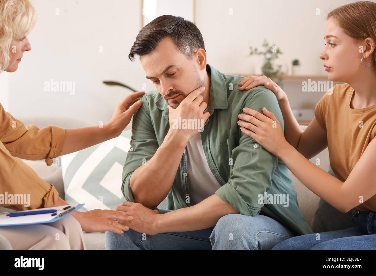 Upset young man with his wife visiting psychologist in office Stock ...