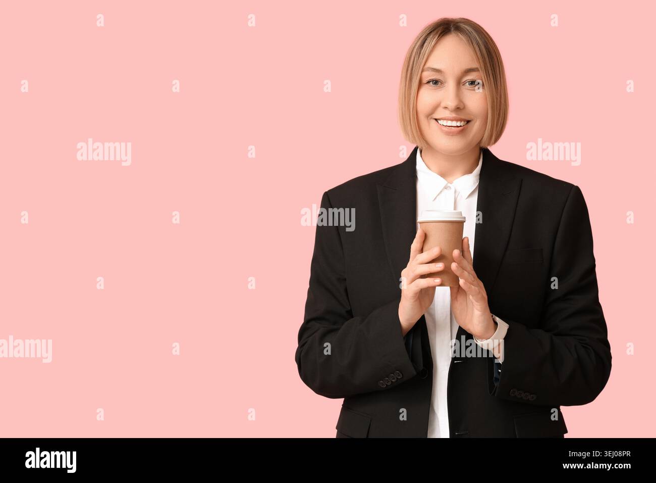 Happy adult woman with paper cup of coffee on pink background Stock ...