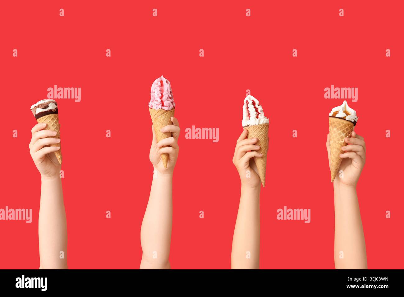 Female hands with different sweet ice-cream in waffle cones on red ...
