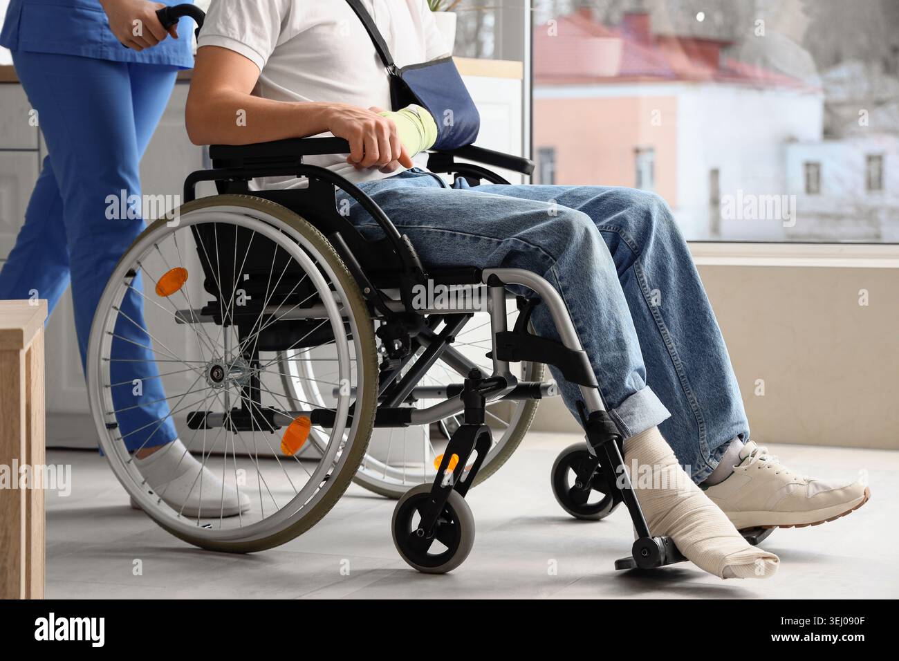 Injured young man in wheelchair after accident with doctor at home ...
