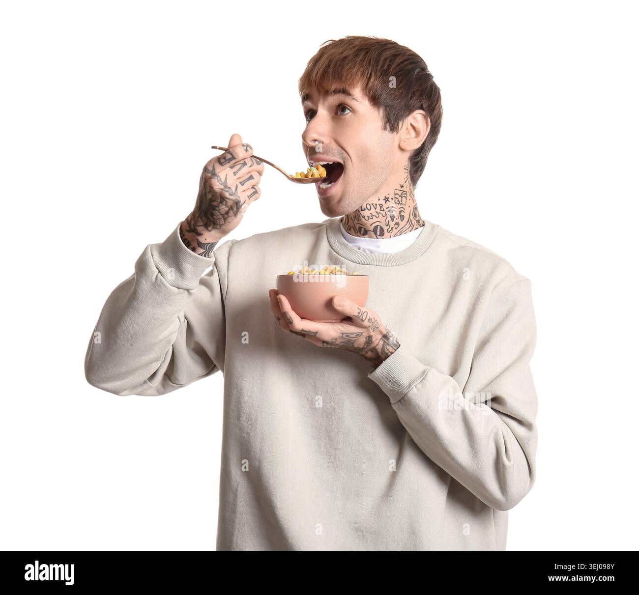 Man eating cereal rings on white background Stock Photo - Alamy
