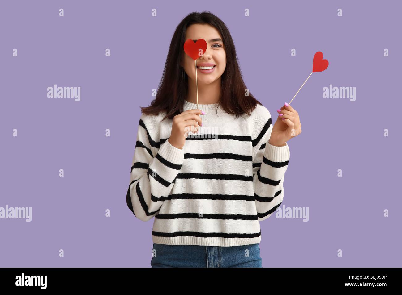 Happy young girl with red paper hearts on purple background. Valentine ...
