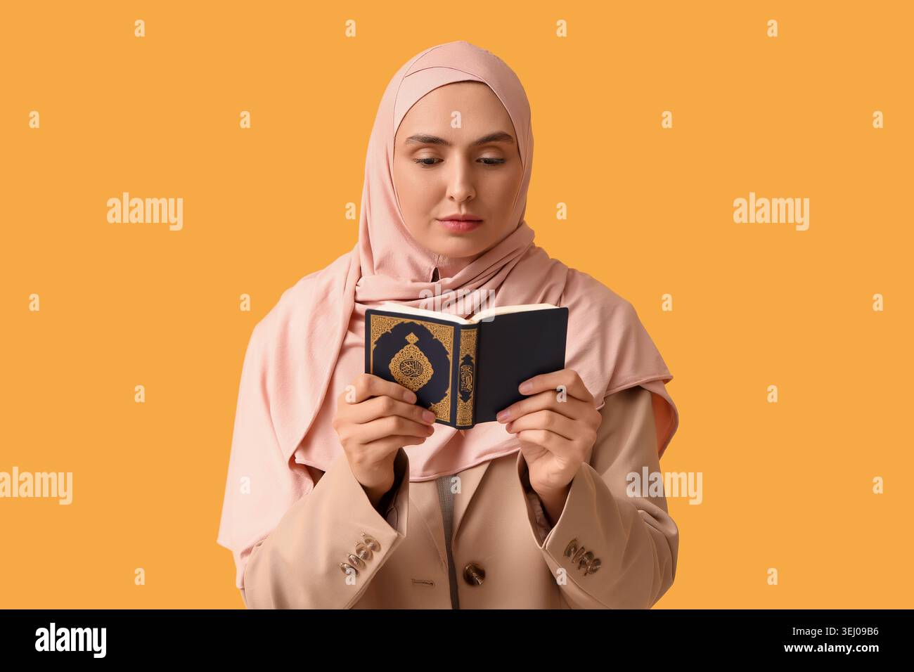 Young Muslim woman with Koran praying on yellow background Stock Photo ...