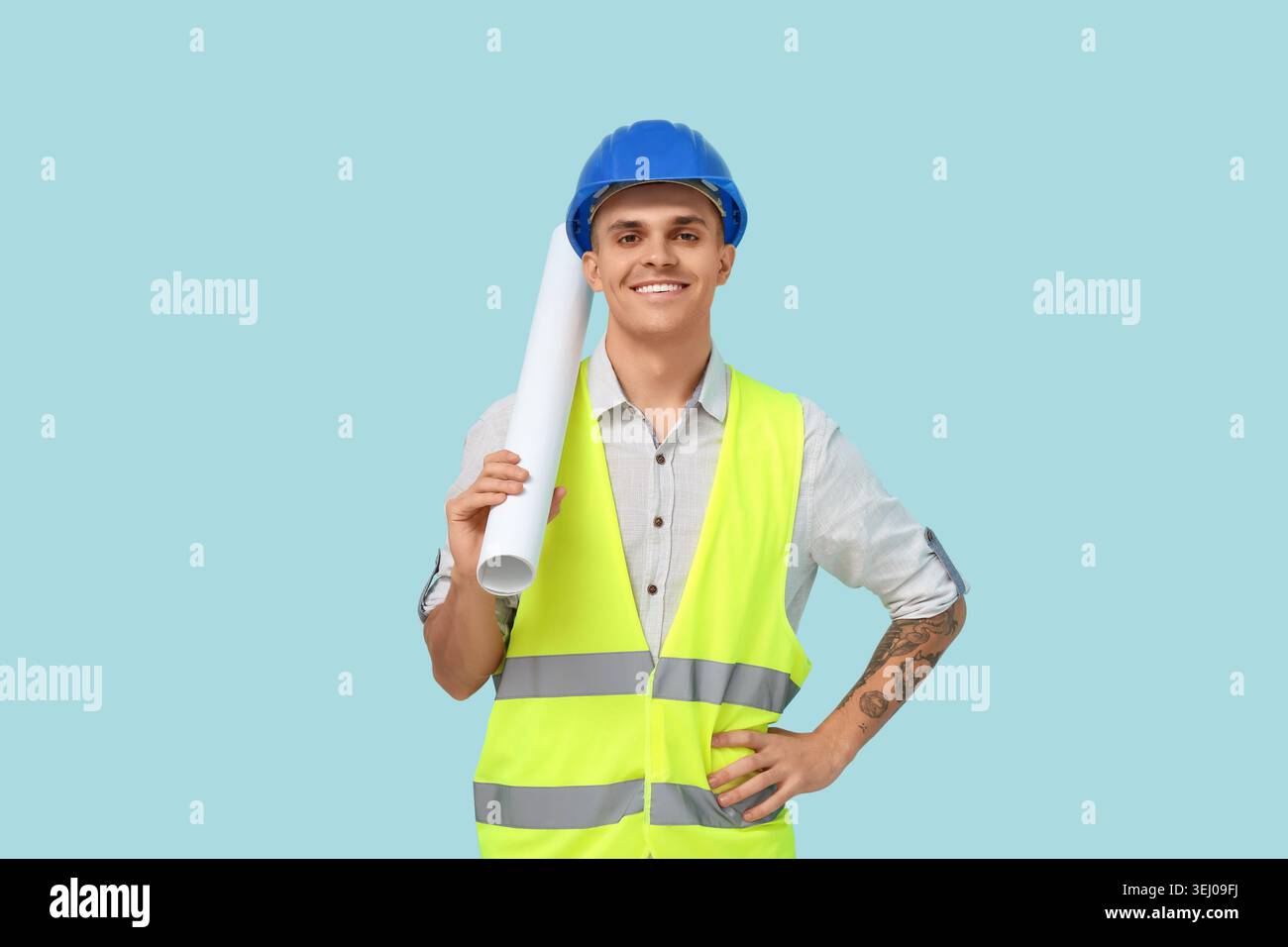 Young male engineer with blueprint on blue background Stock Photo - Alamy