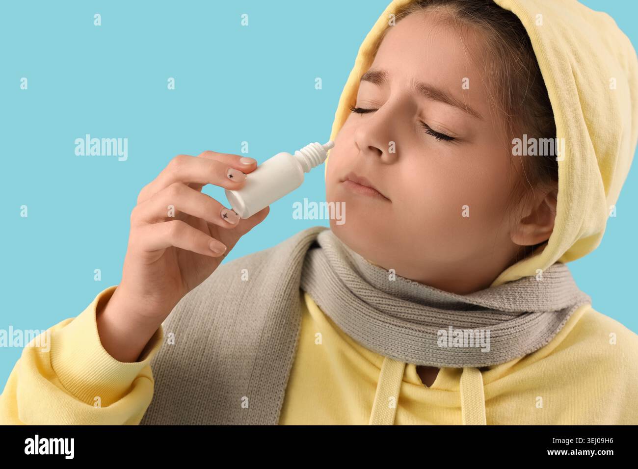Sick little girl with nasal drops on blue background, closeup Stock ...