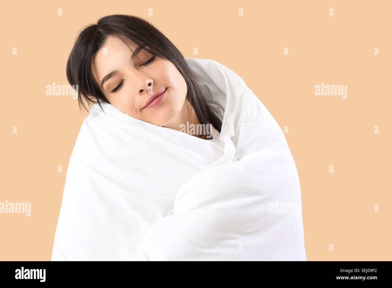 Beautiful happy young woman with soft blanket sleeping on pale orange ...