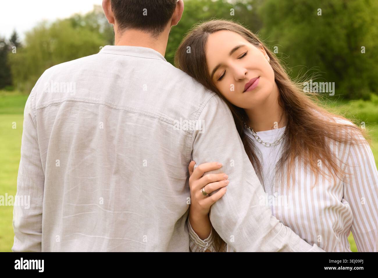 Beautiful loving couple hugging and walking in park on spring day Stock ...