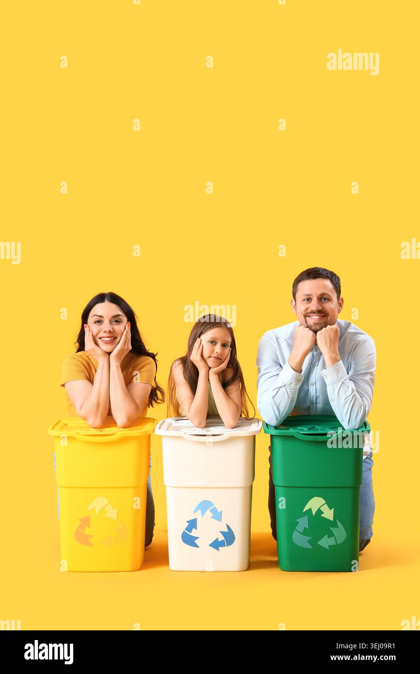 Family with recycle bins on yellow background Stock Photo - Alamy