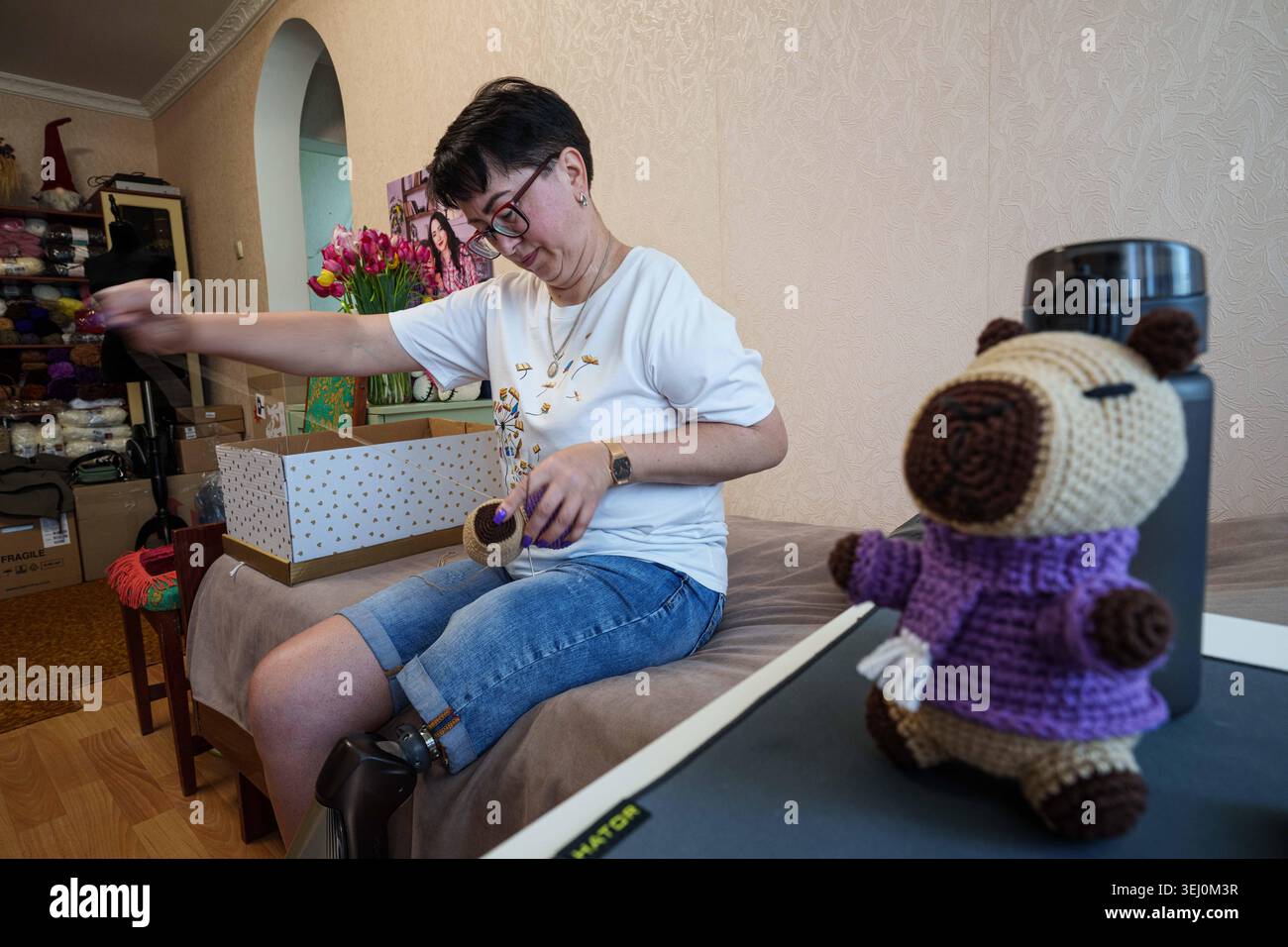 Iryna Nakonechna knits a toy capybara at her home in Kryvyi Rih ...