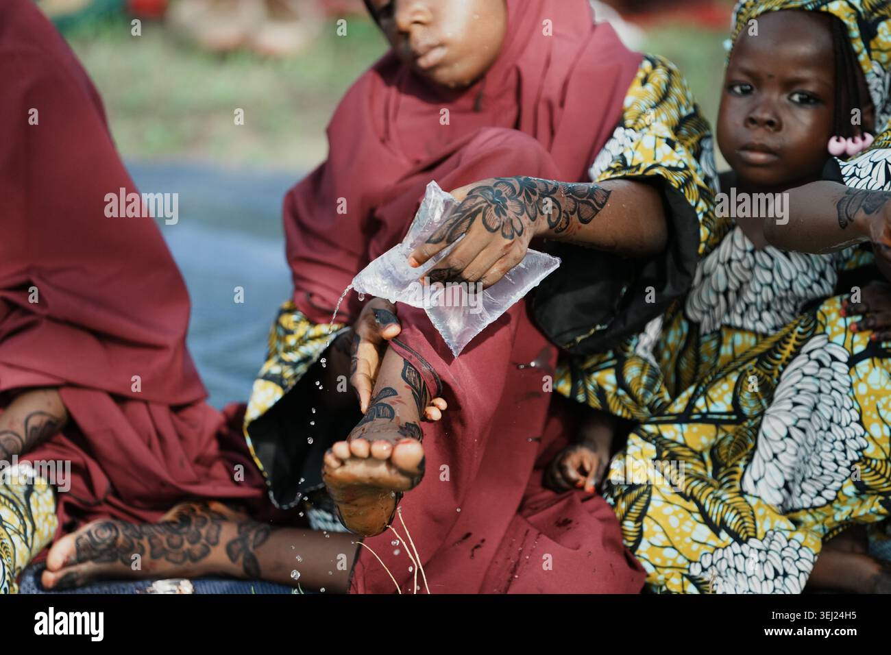 A Muslim woman performs ablution before Eid al-Adha prayers in an open ...