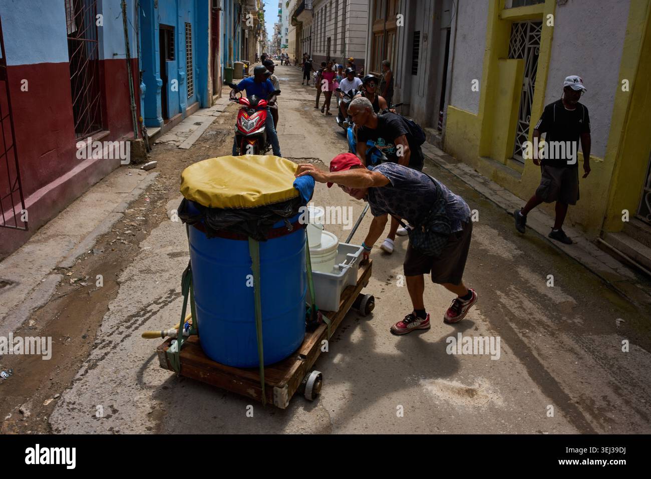 People transport containers of water in Havana, Wednesday, May 27, 2026 ...