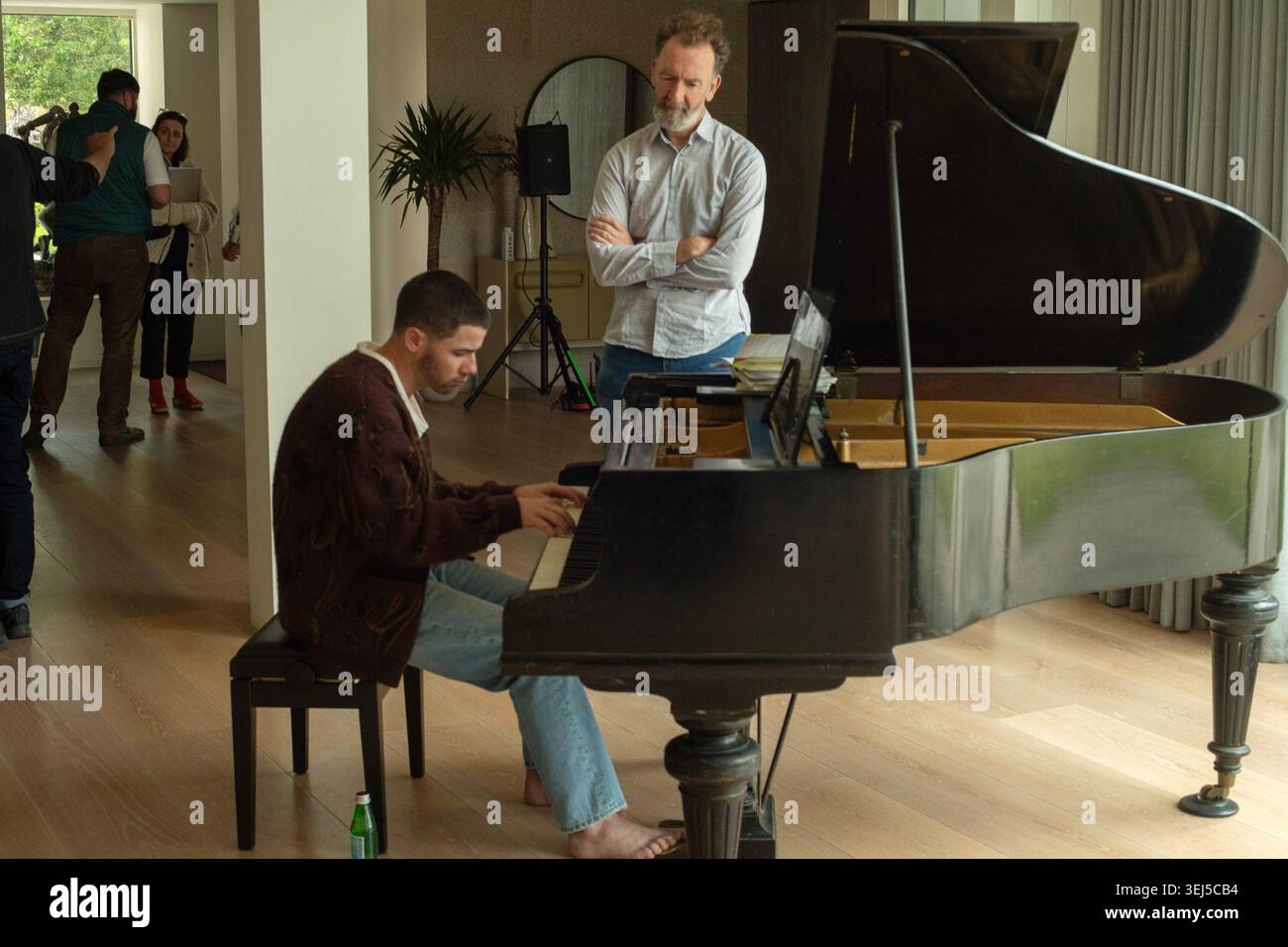 POWER BALLAD, from left: Nick Jonas, director John Carney, on set, 2026 ...
