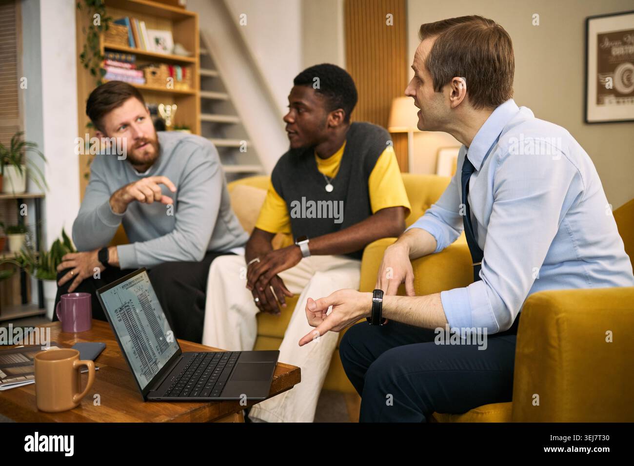 Young adult men discussing ideas during casual meeting, showing male ...