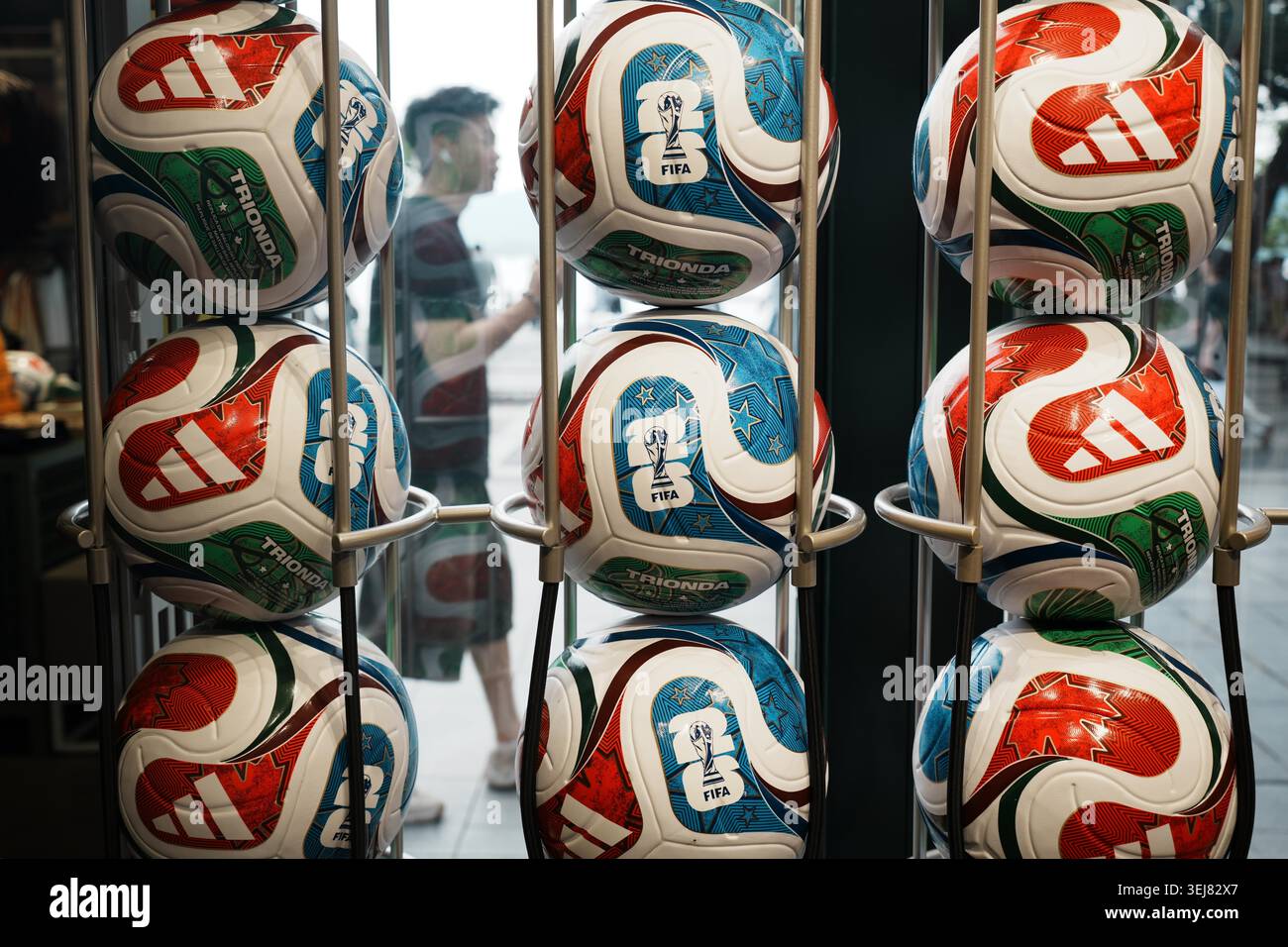 Customers walk past the official match ball of the 2026 World Cup at a ...