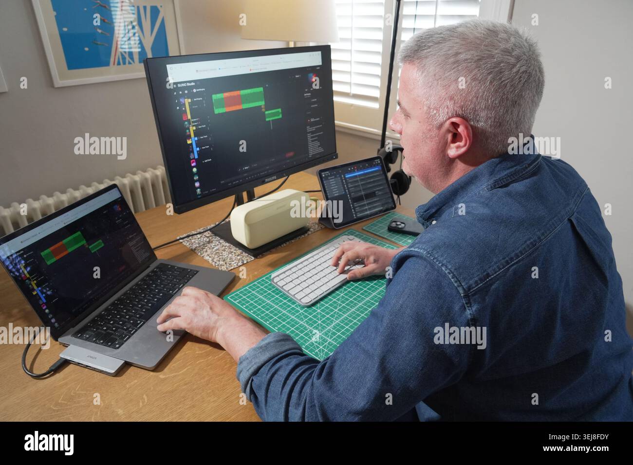 Musician Samuel Smith edits audio at his home, in London, Tuesday, May ...