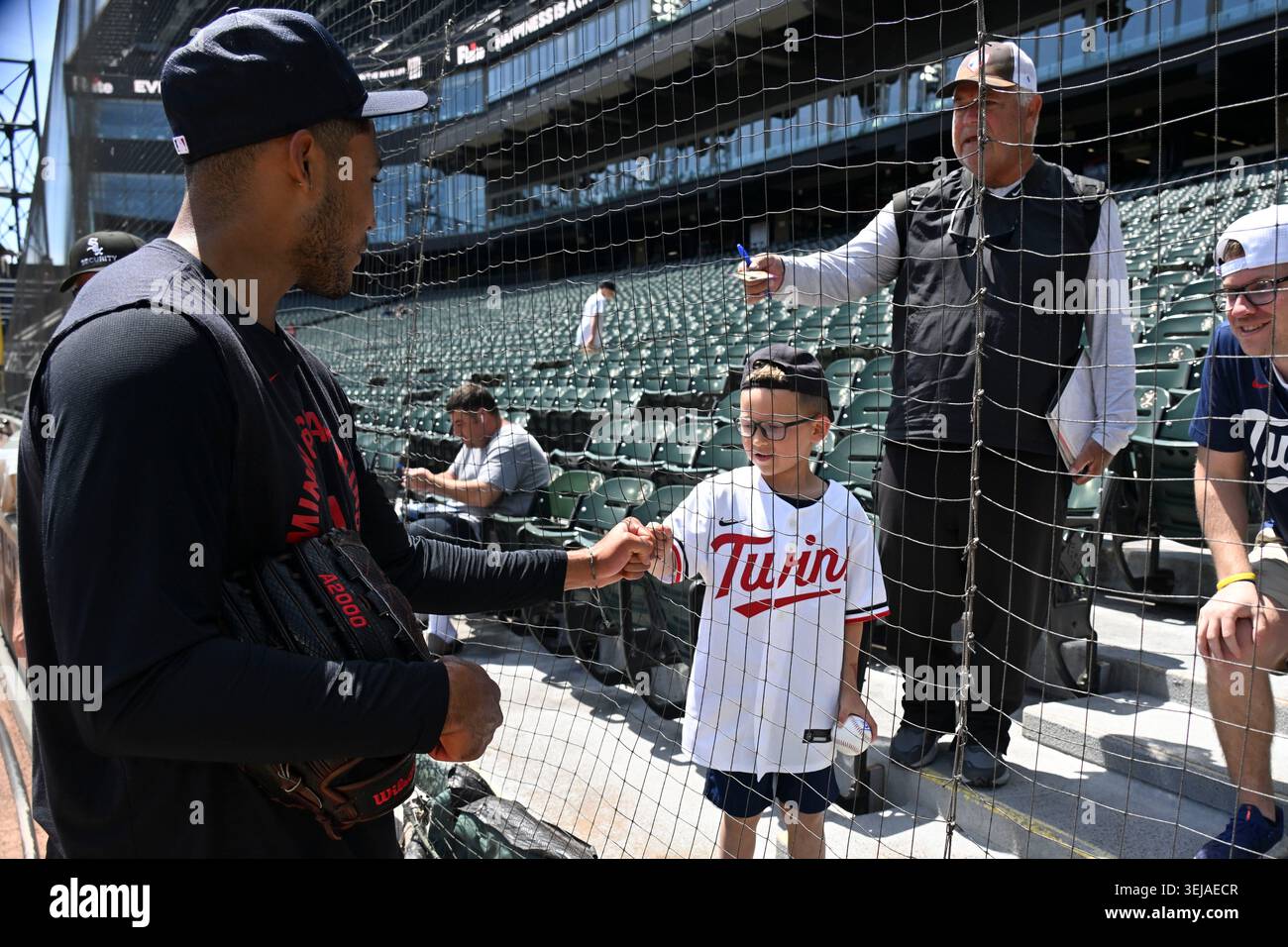 Minnesota Twins pitcher Taj Bradley, left, fist bumps a fan before a ...