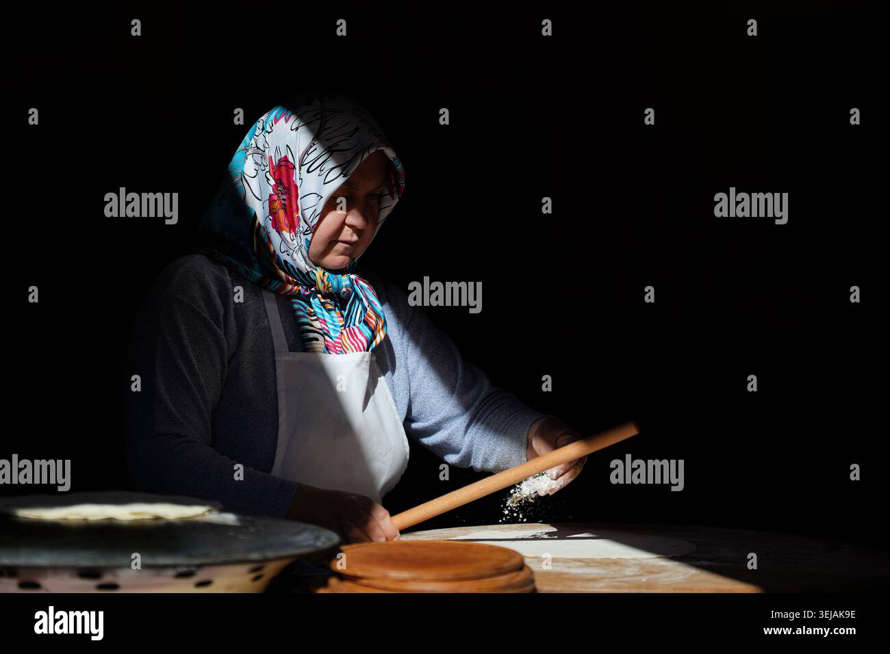 May 25, 2026, Istanbul, Turkey: A woman kneading bread inside a shop in ...
