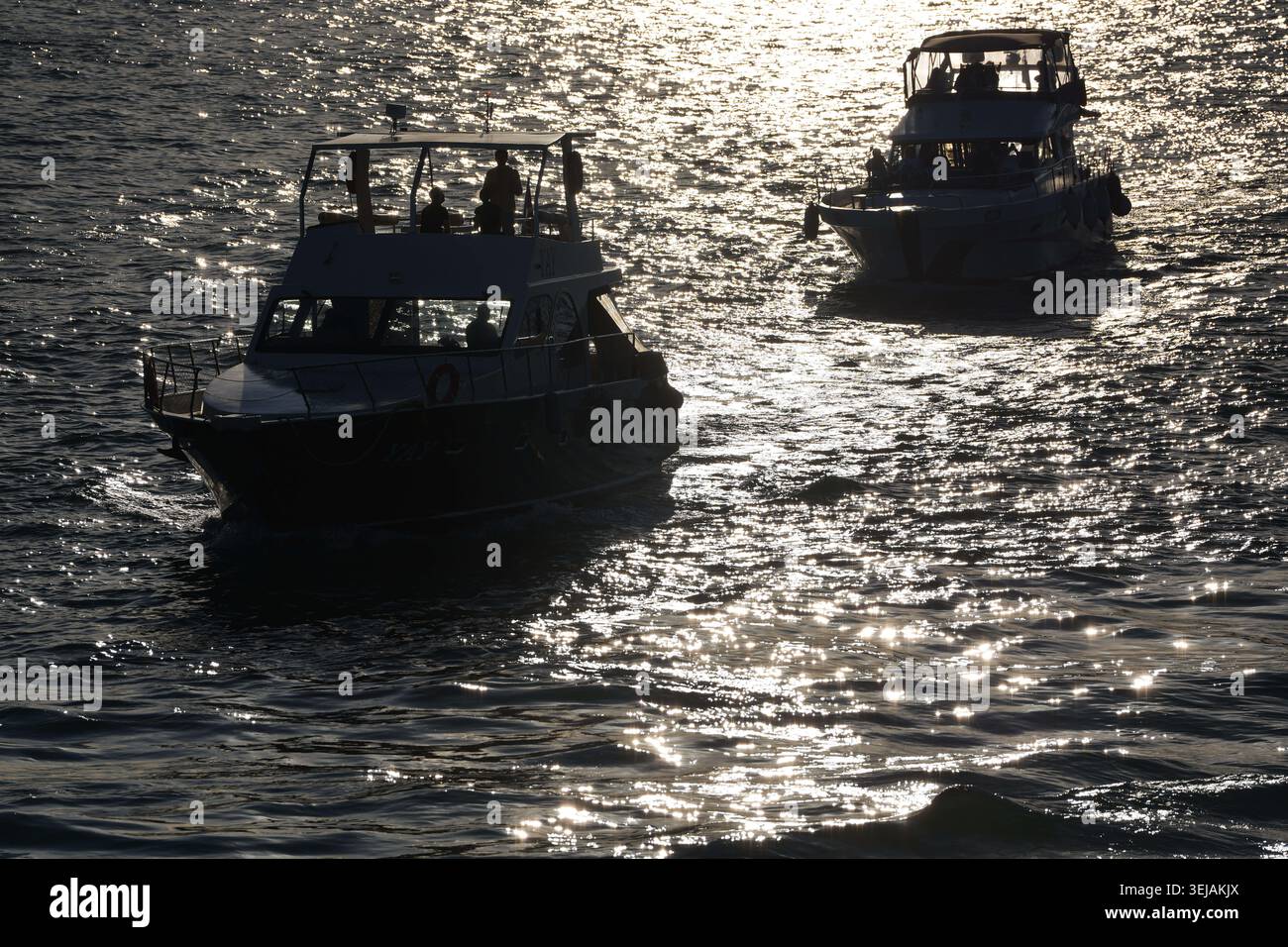 May 25, 2026, Istanbul, Turkey: Silhouetted ships sail in the Bosphorus ...