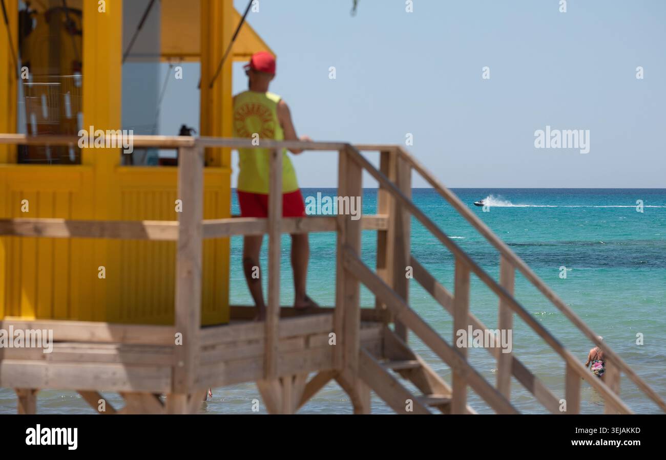 28 May 2026, Spain, Palma de Mallorca: A lifeguard at his watchtower on ...