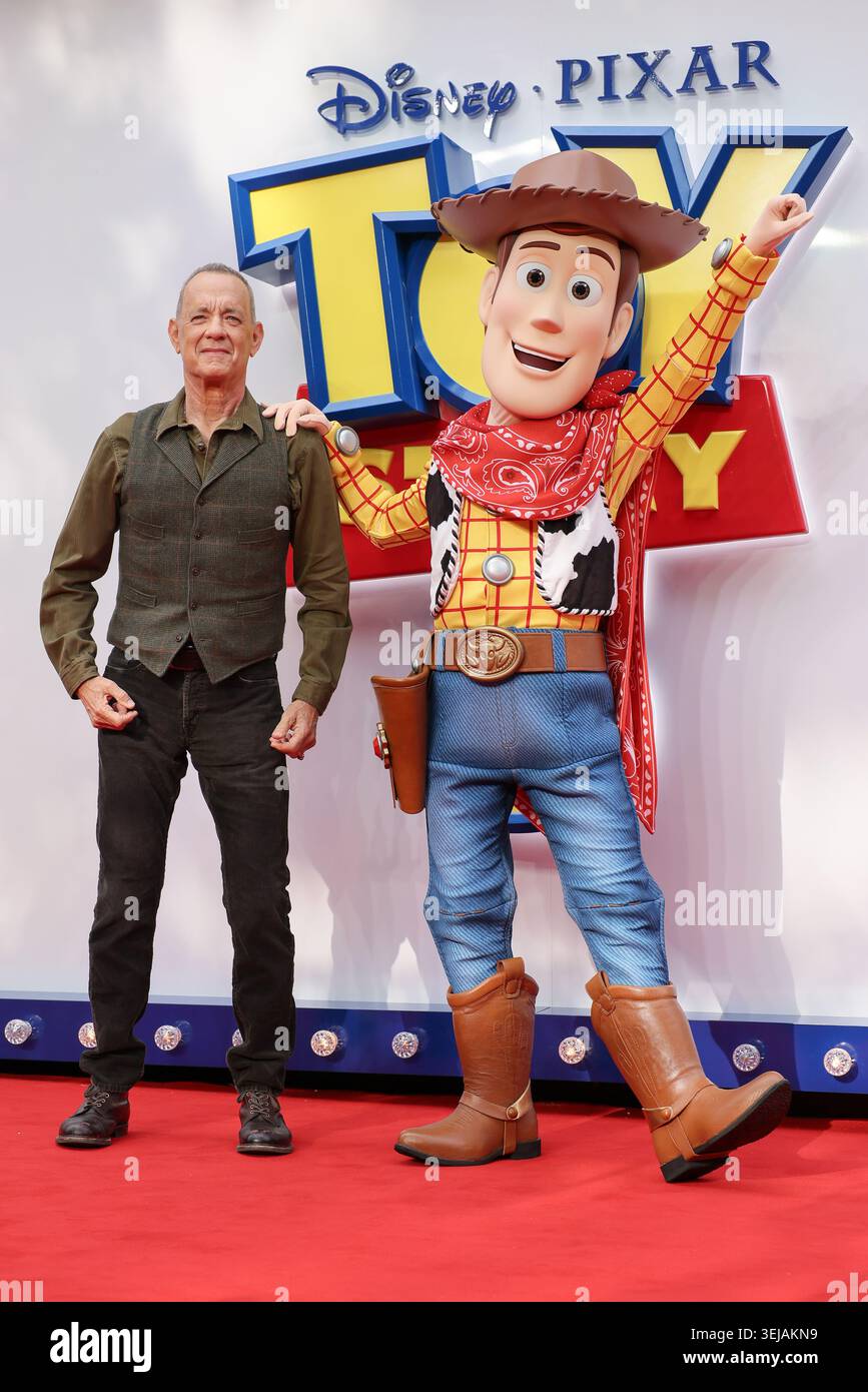 Tom Hanks, left, and a person costumed as the character Woody pose for ...