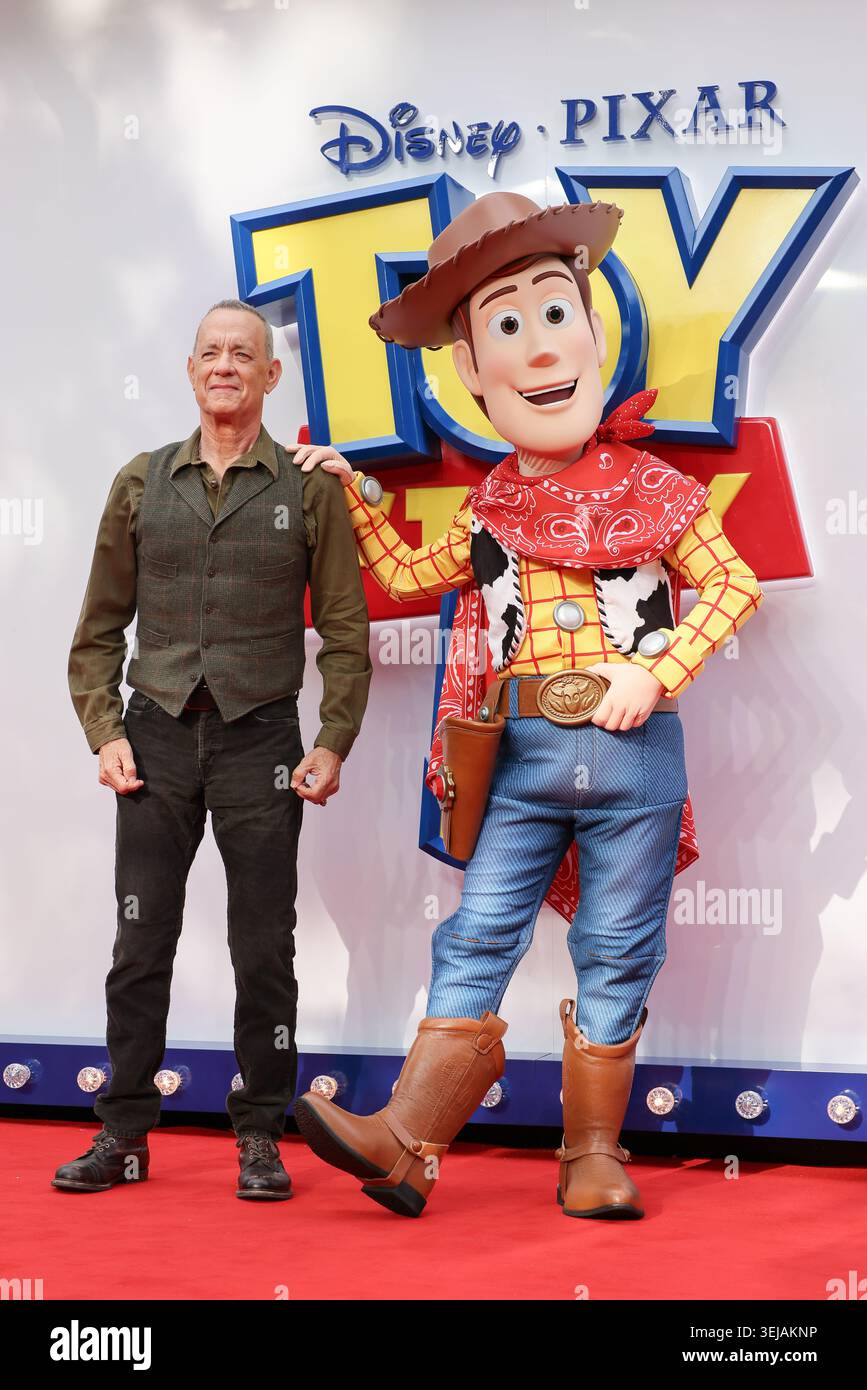 Tom Hanks, left, and a person costumed as the character Woody pose for ...