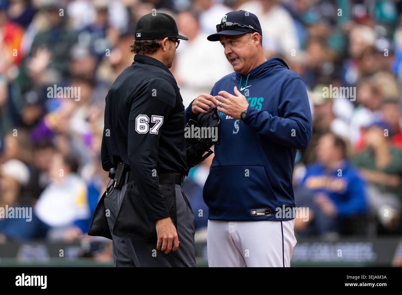 Seattle Mariners manager Dan Wilson, right, talks with home plate ...