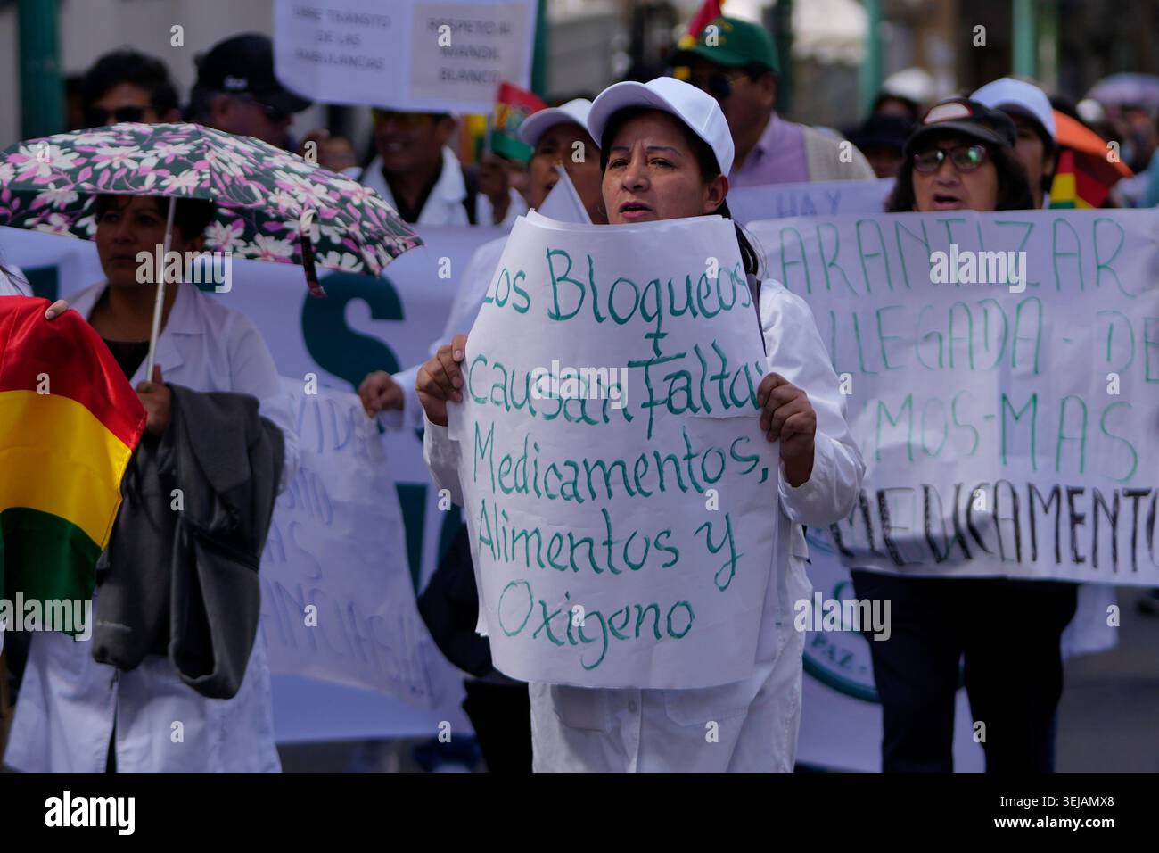 A health worker a holds sign that reads in Spanish, "The blockades ...