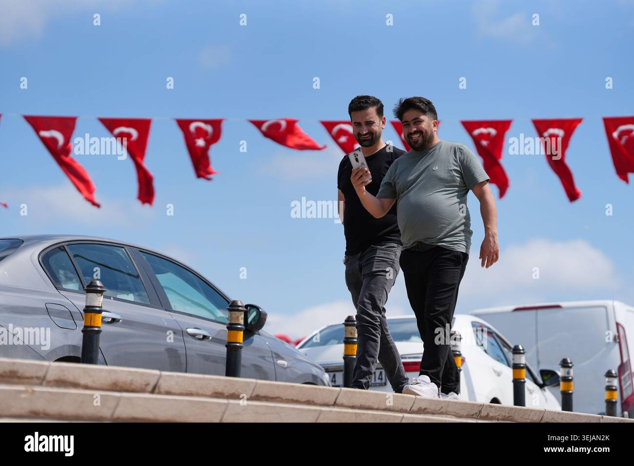 May 24, 2026, Istanbul, Turkey: Two young men walk along the coast of ...
