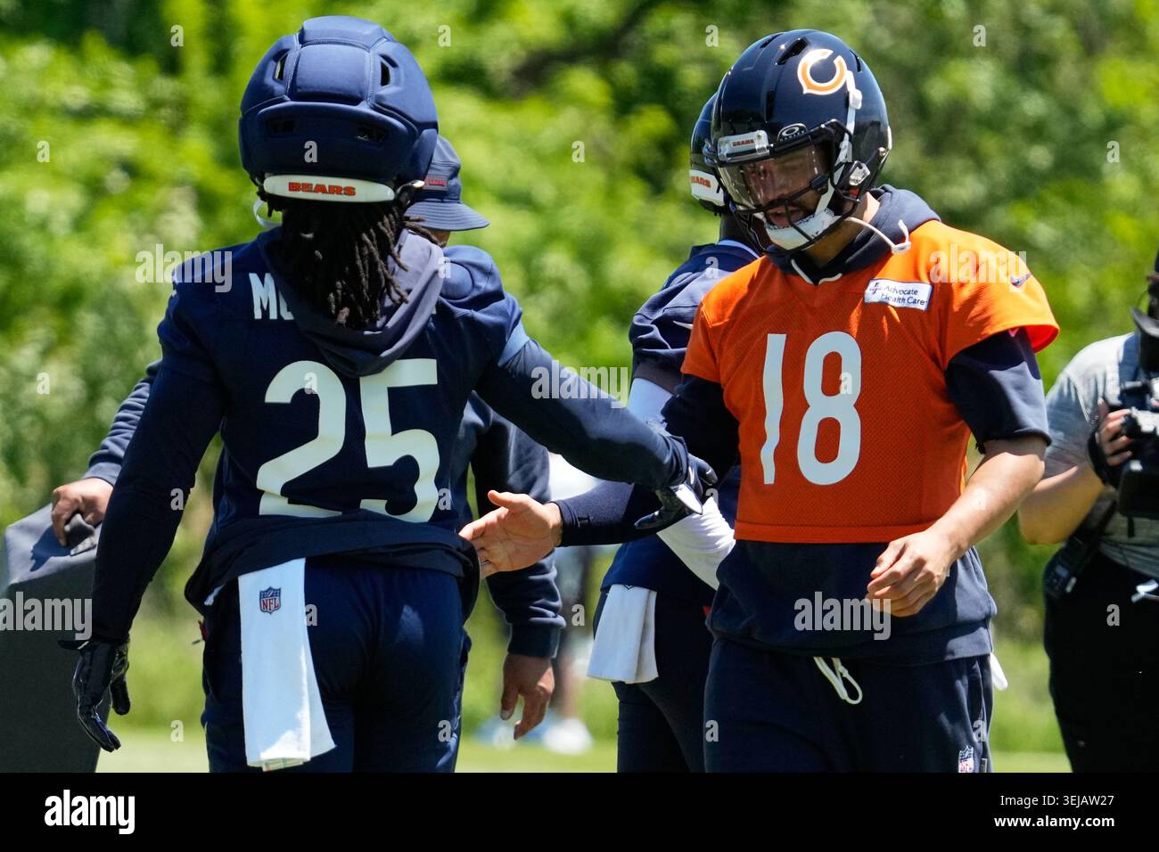 Chicago Bears quarterback Caleb Williams, right, greets running back ...
