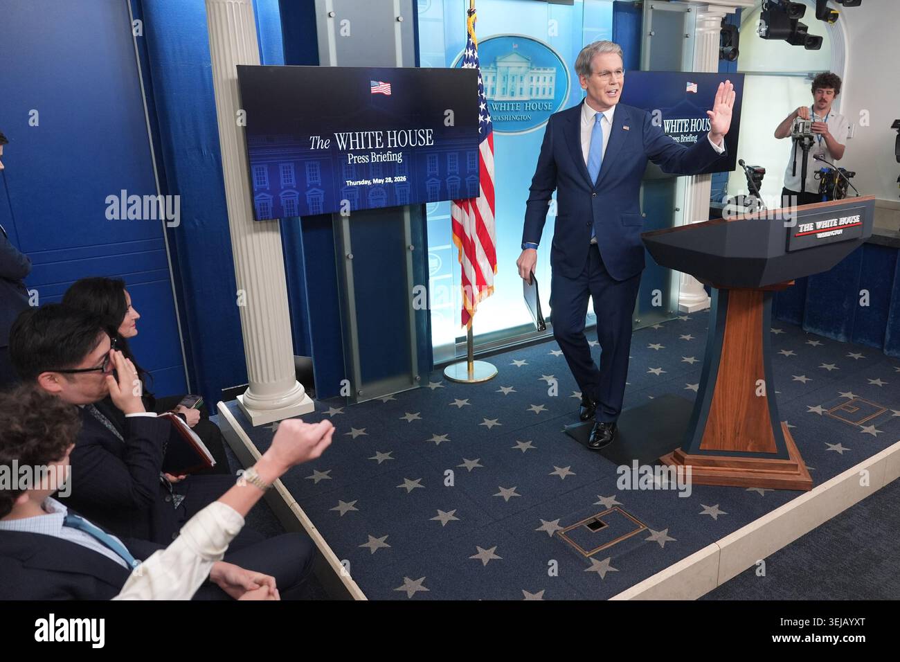 Treasury Secretary Scott Bessent waves as he concludes a briefing with ...