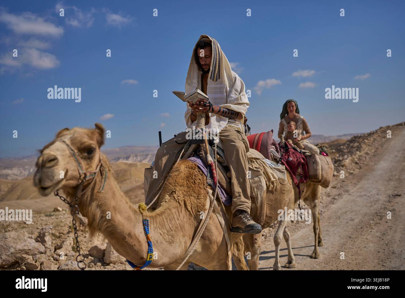 Israeli settler parents travel with their baby on camels in the ...
