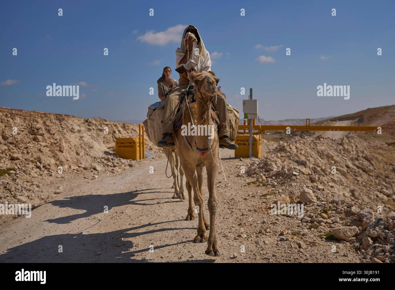Israeli settler parents travel with their baby on camels in the ...