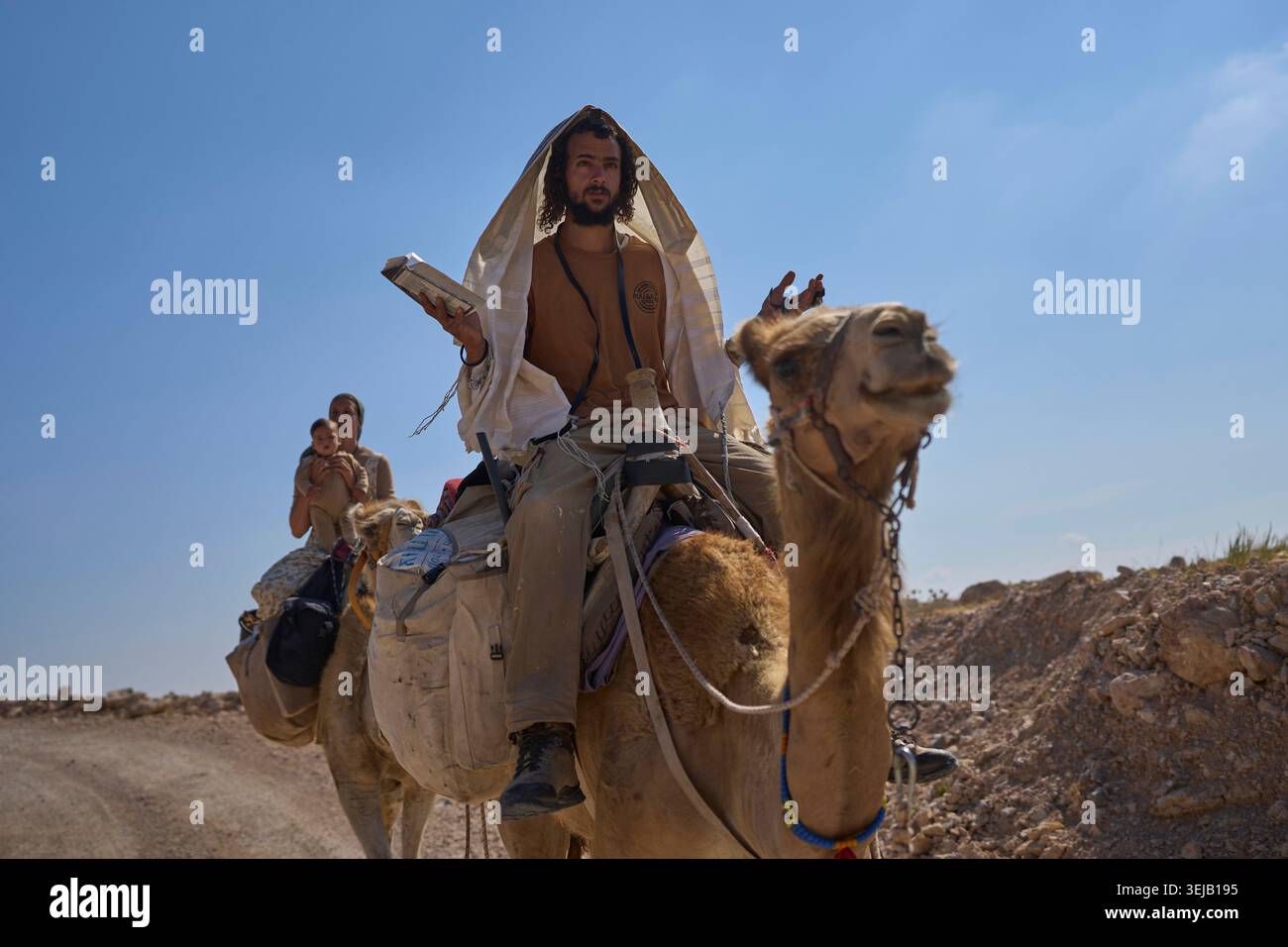 Israeli settler parents travel with their baby on camels in the ...
