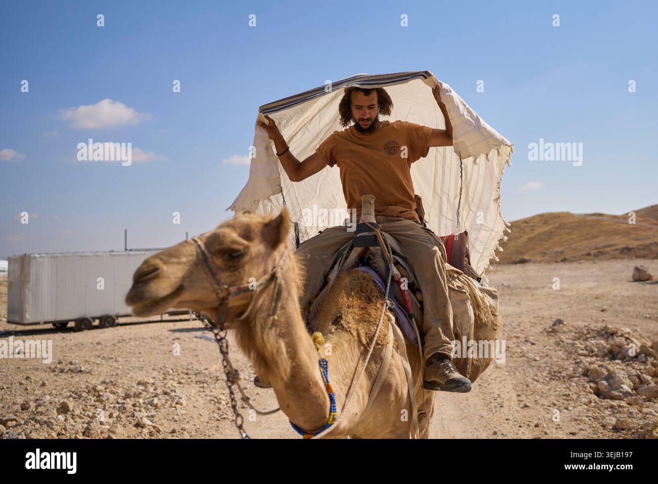 Israeli settler parents travel with their baby on camels in the ...
