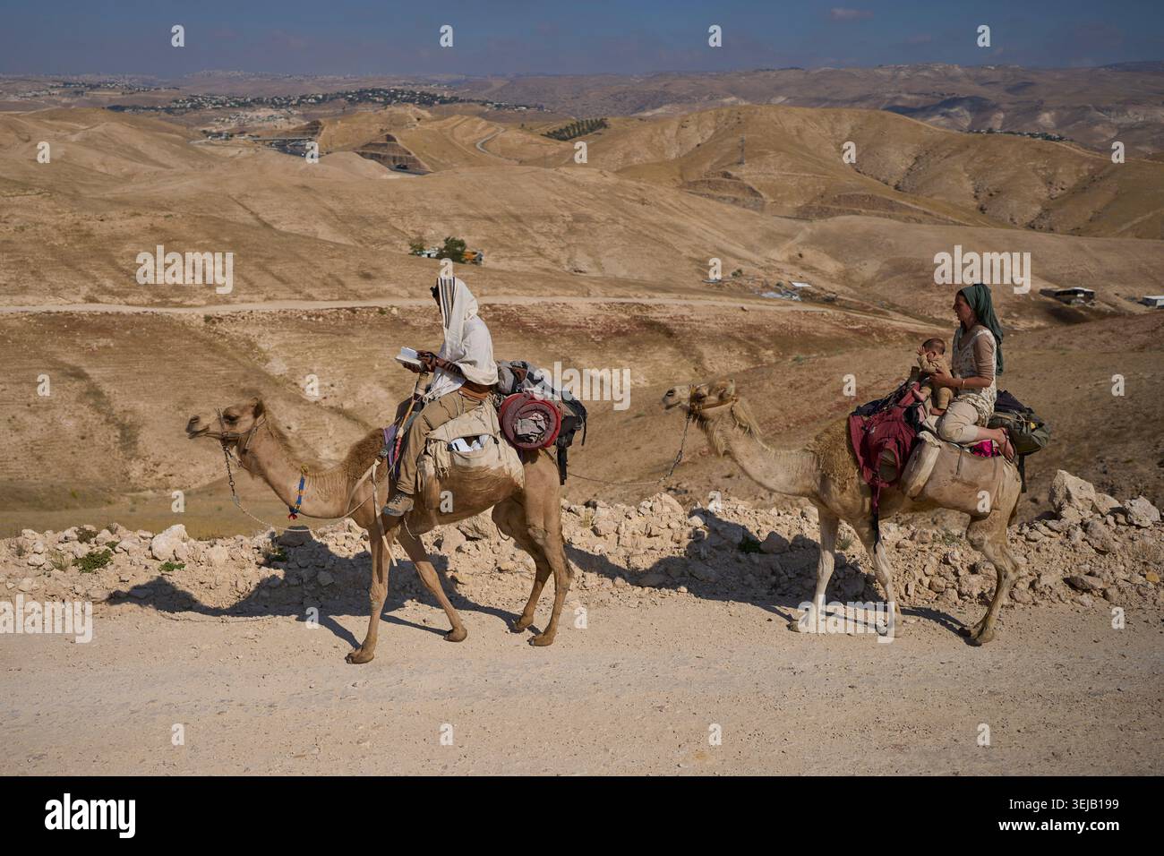 Israeli settler parents travel with their baby on camels in the ...