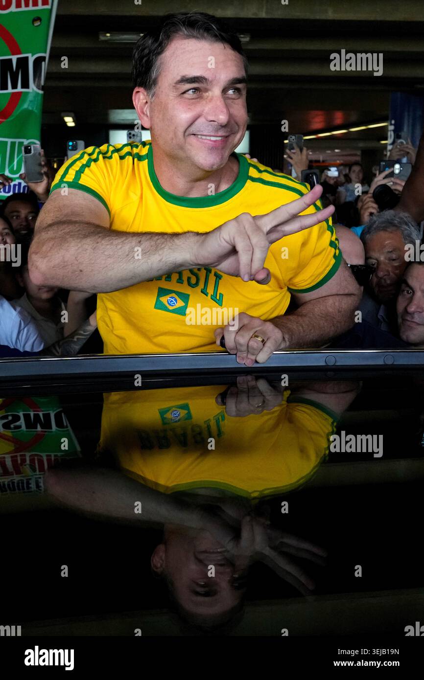 Sen. Flavio Bolsonaro gestures to supporters upon arriving at Brasília ...