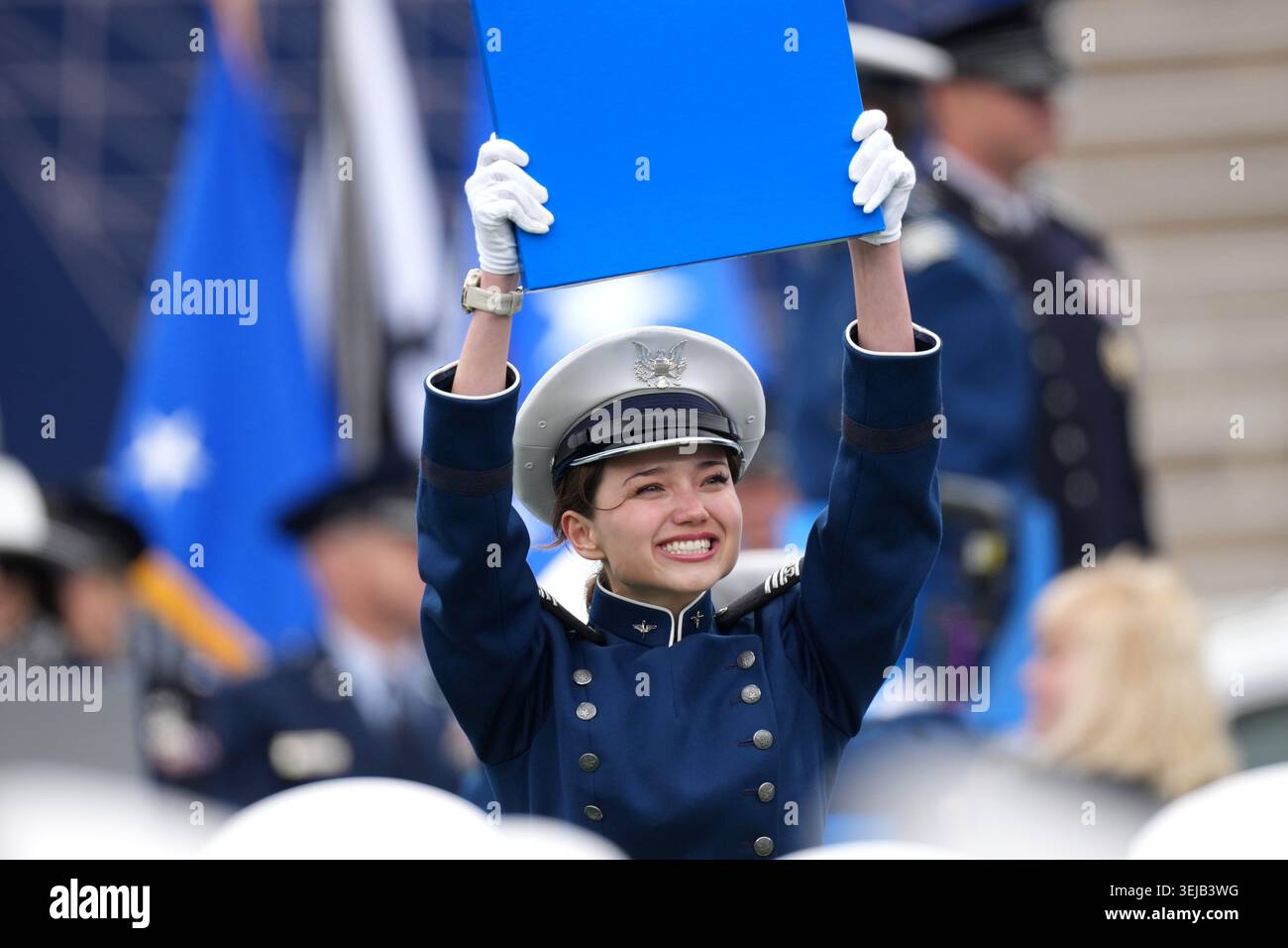 A cadet holds up a diploma during the United States Air Force Academy ...