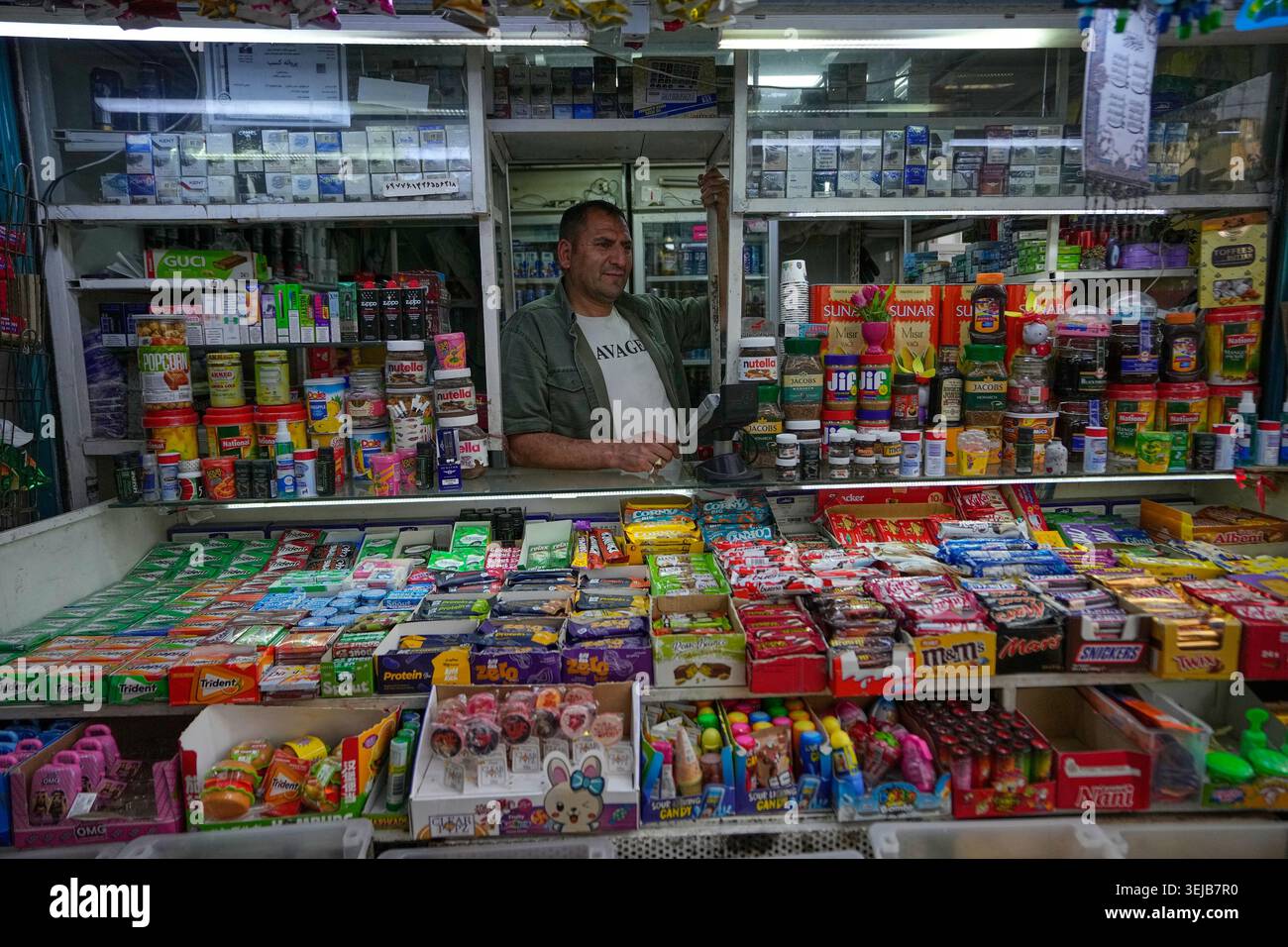 A man looks out of his kiosk near the old main bazaar of Tehran, Iran ...