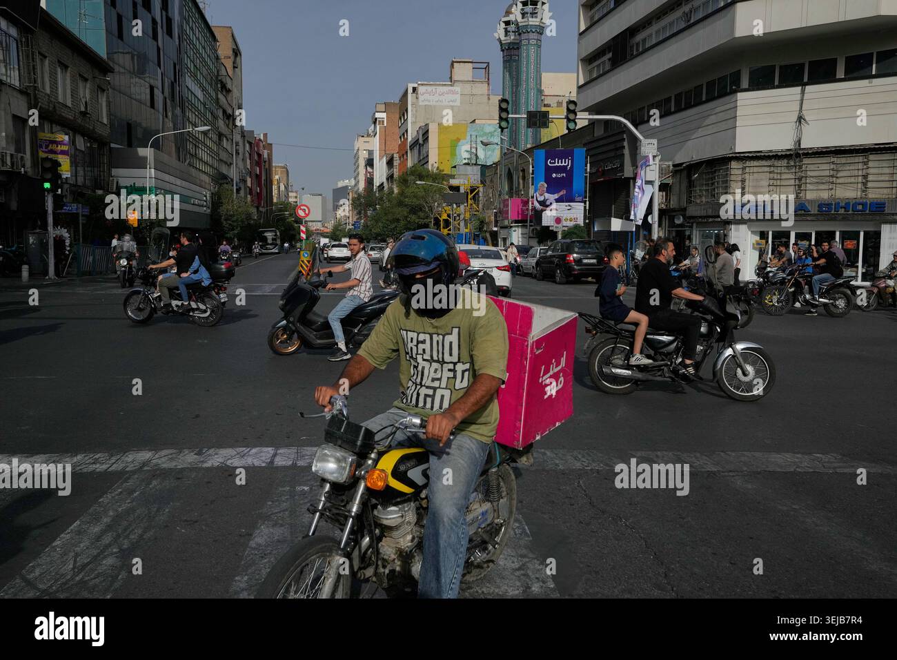 Motorbikes cross an intersection in downtown Tehran, Iran, Thursday ...