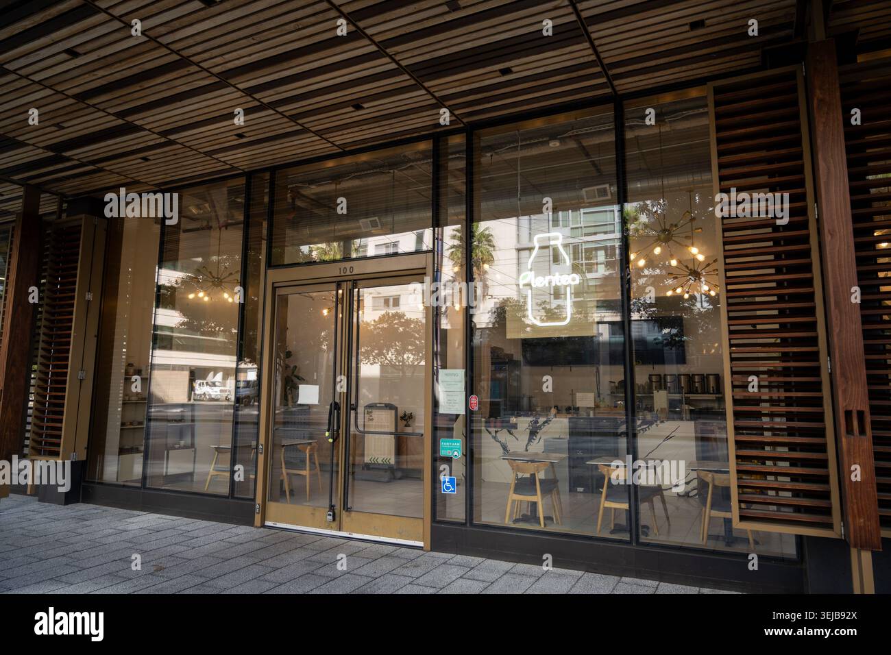 Exterior of Plentea cafe with glass facade, wooden accents, and visible ...