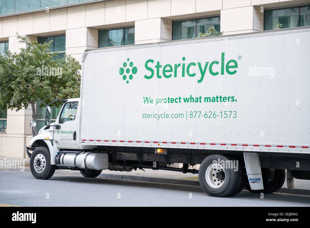 Stericycle branded delivery truck parked on city street in front of ...