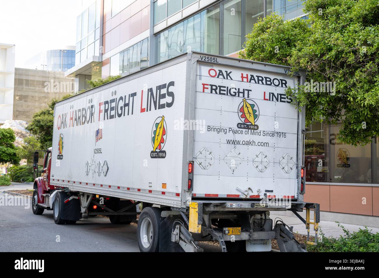 Oak Harbor Freight Lines delivery truck parked beside modern commercial ...