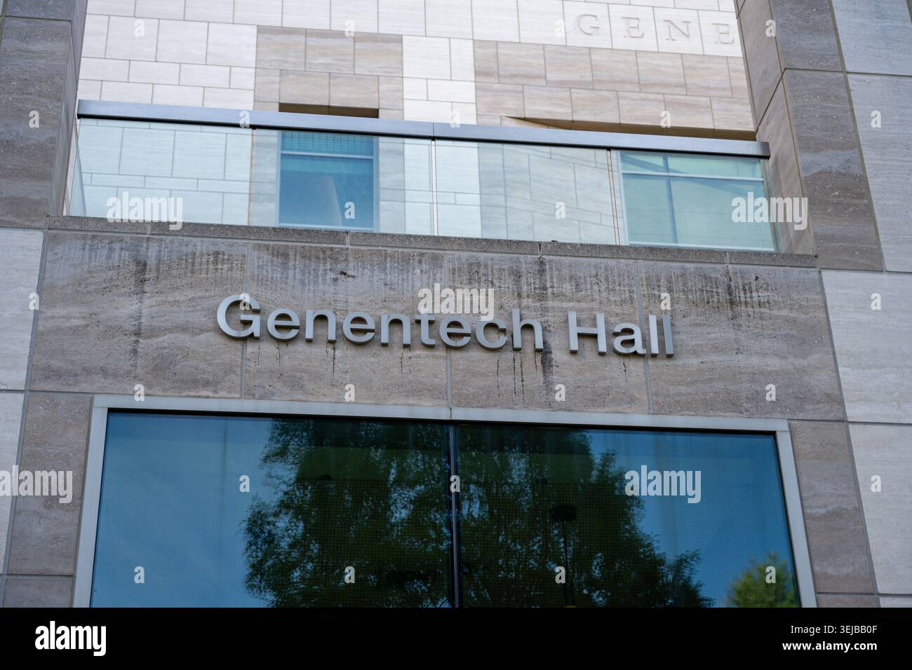 Exterior of Genentech Hall building with name signage and modern glass ...