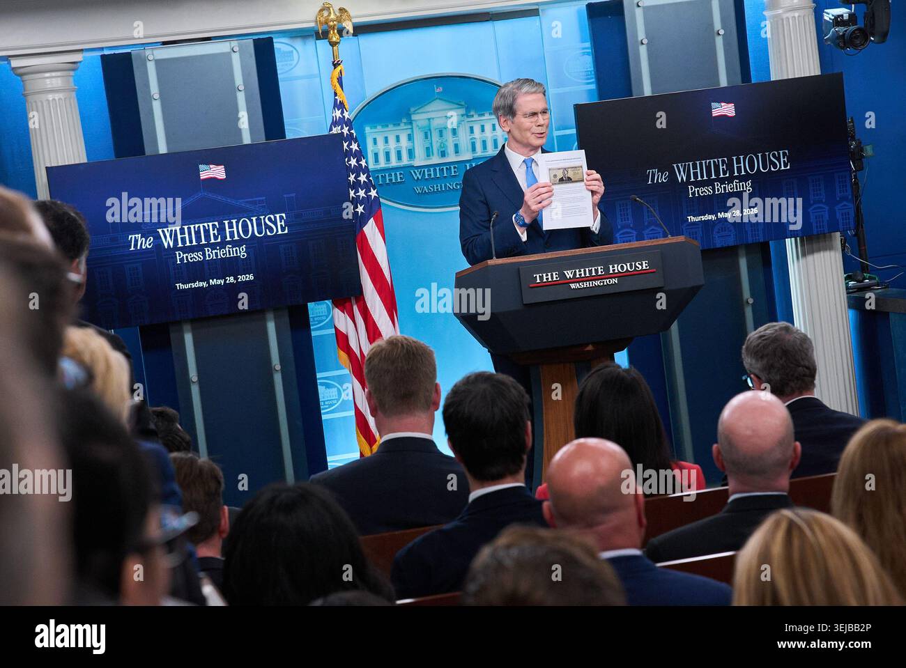 Treasury Secretary Scott Bessent holds up an image of the proposed 250 ...
